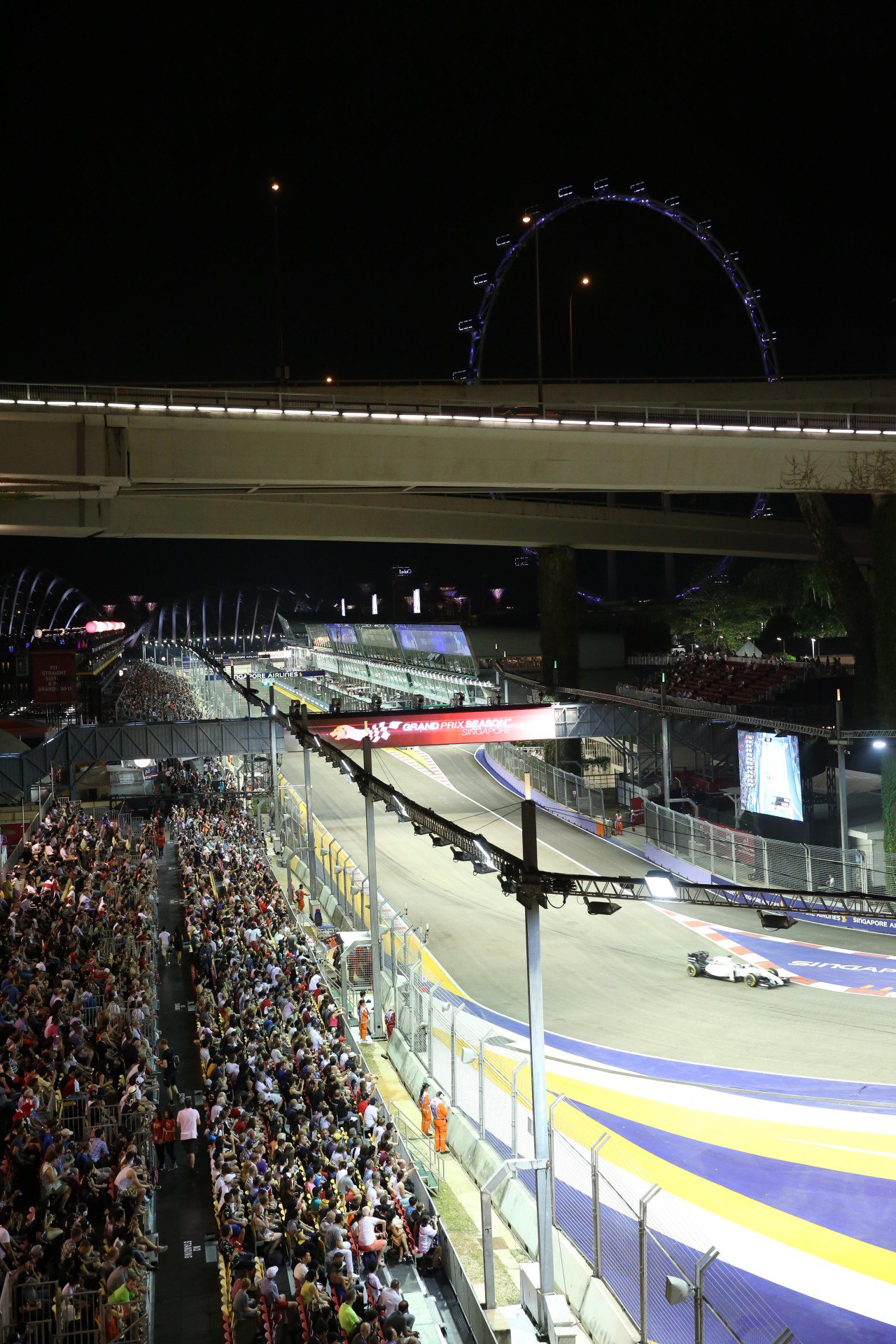 Turn 1 Grandstand spectators watch as the cars tackle the first turn ...
